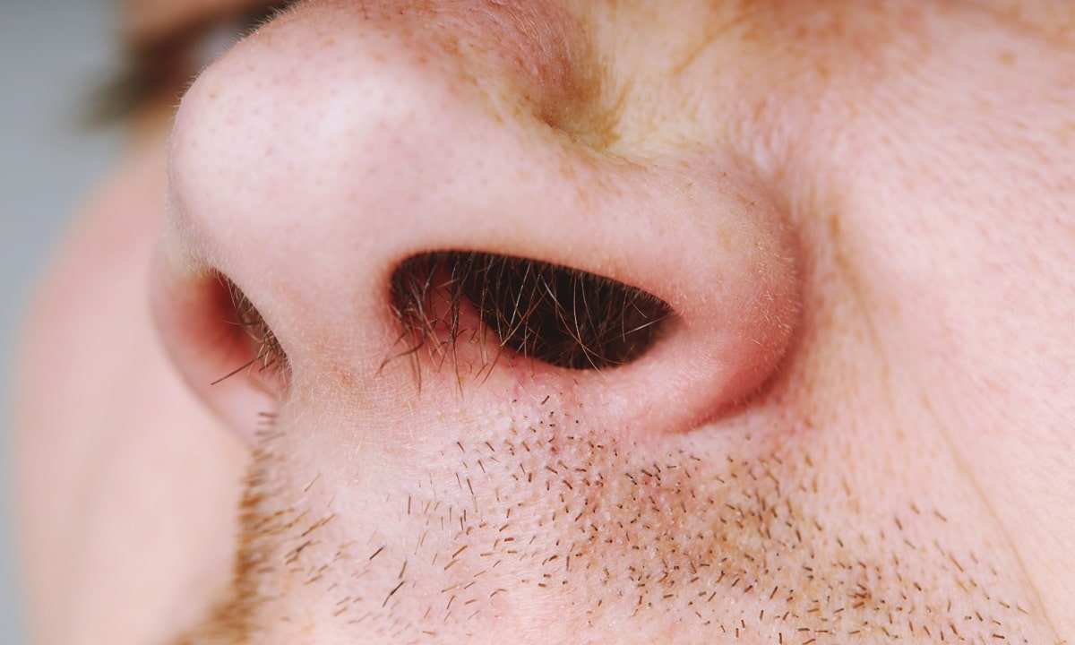 male nose with a long hair. body care concept. macro